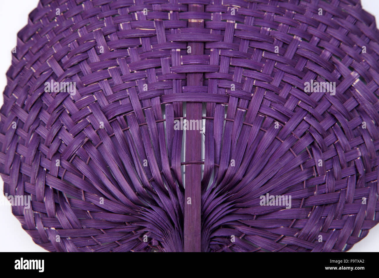 Purple color native fan made from palm leaves on white background Stock ...
