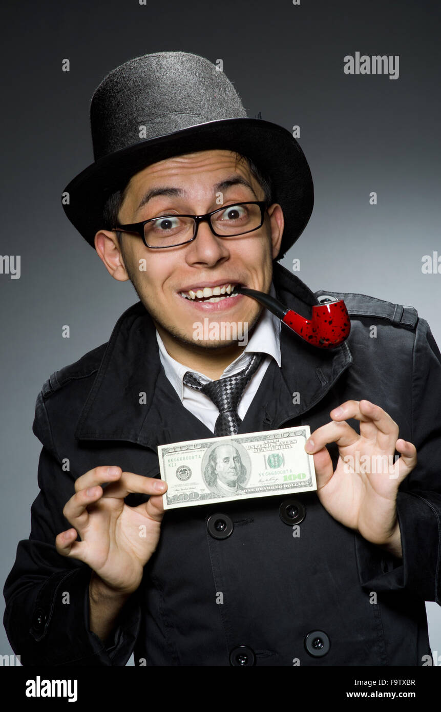 Young detective in black coat with money against gray Stock Photo - Alamy