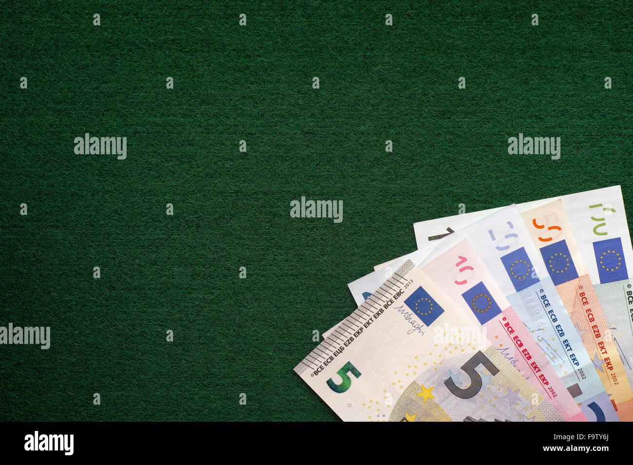 Euro banknotes heap on a green background. Vignette Stock Photo - Alamy