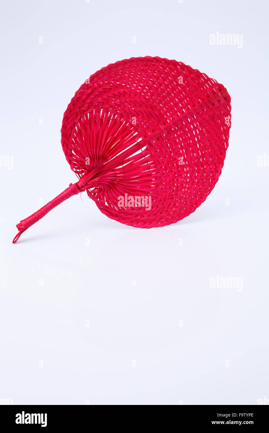 Pink color native fan made from palm leaves on white background Stock ...