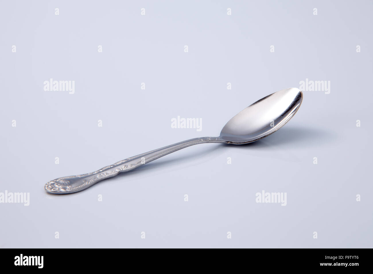 Metal tea spoon isolated on white Stock Photo - Alamy