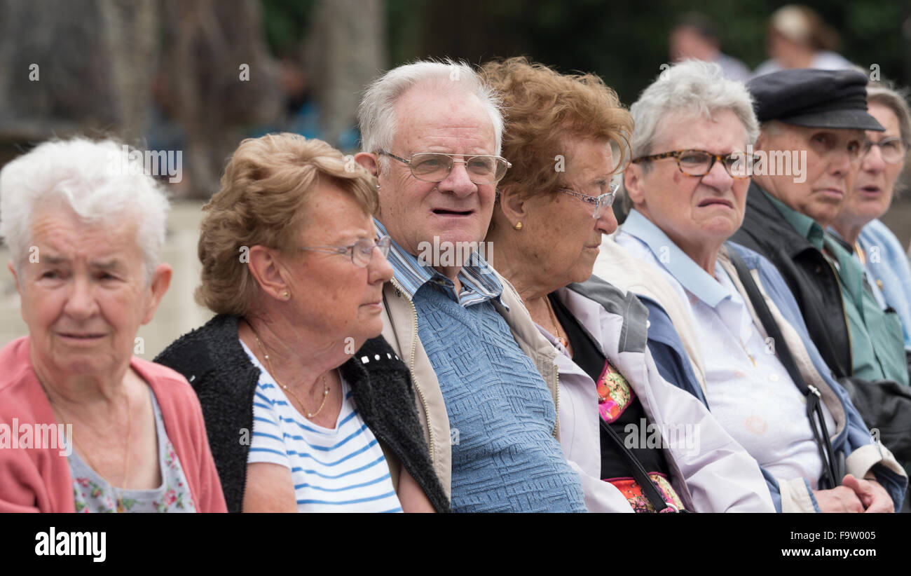 A line of older people waiting for a guide to visit Carcassonne Stock ...