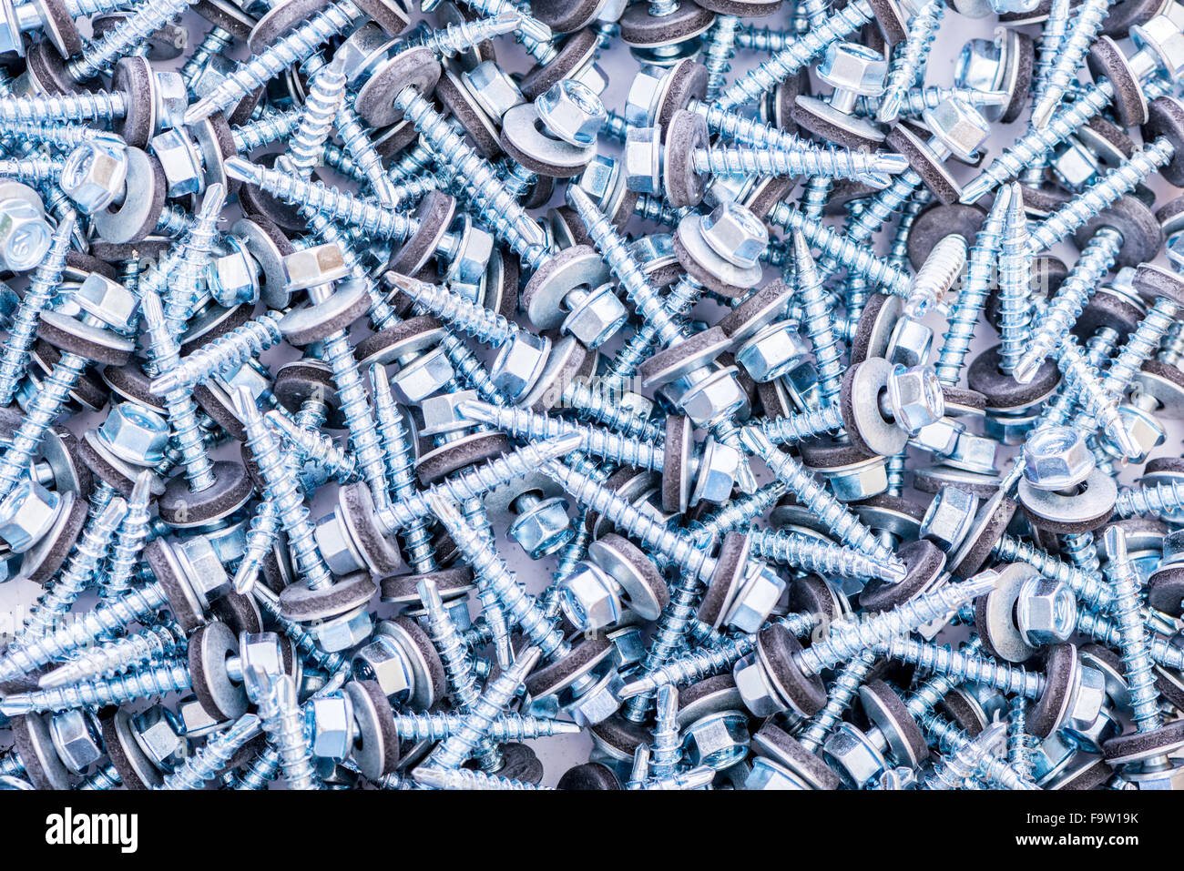Many screws arranged as background Stock Photo - Alamy