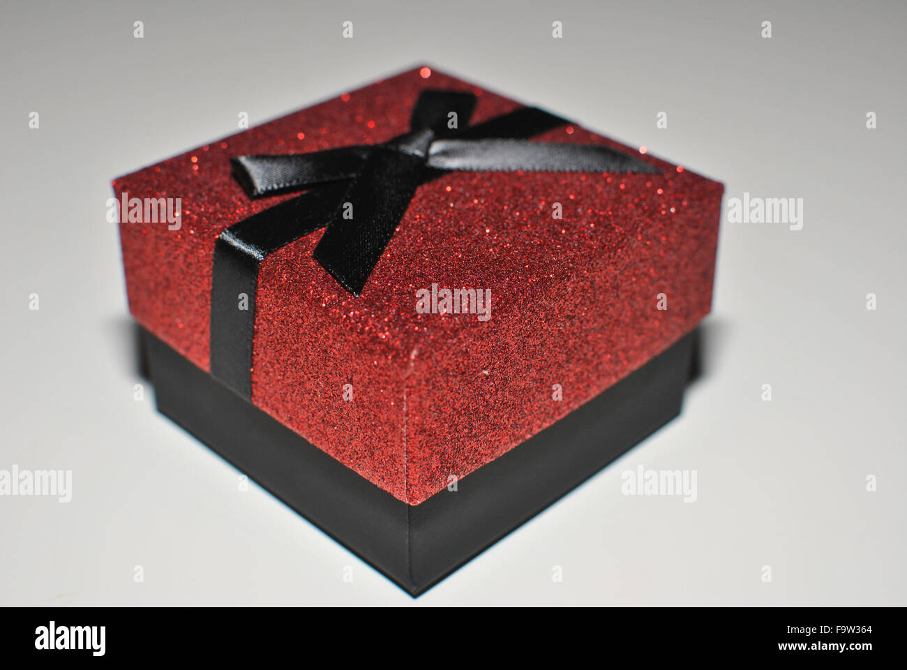 present in red box with black bow Stock Photo - Alamy