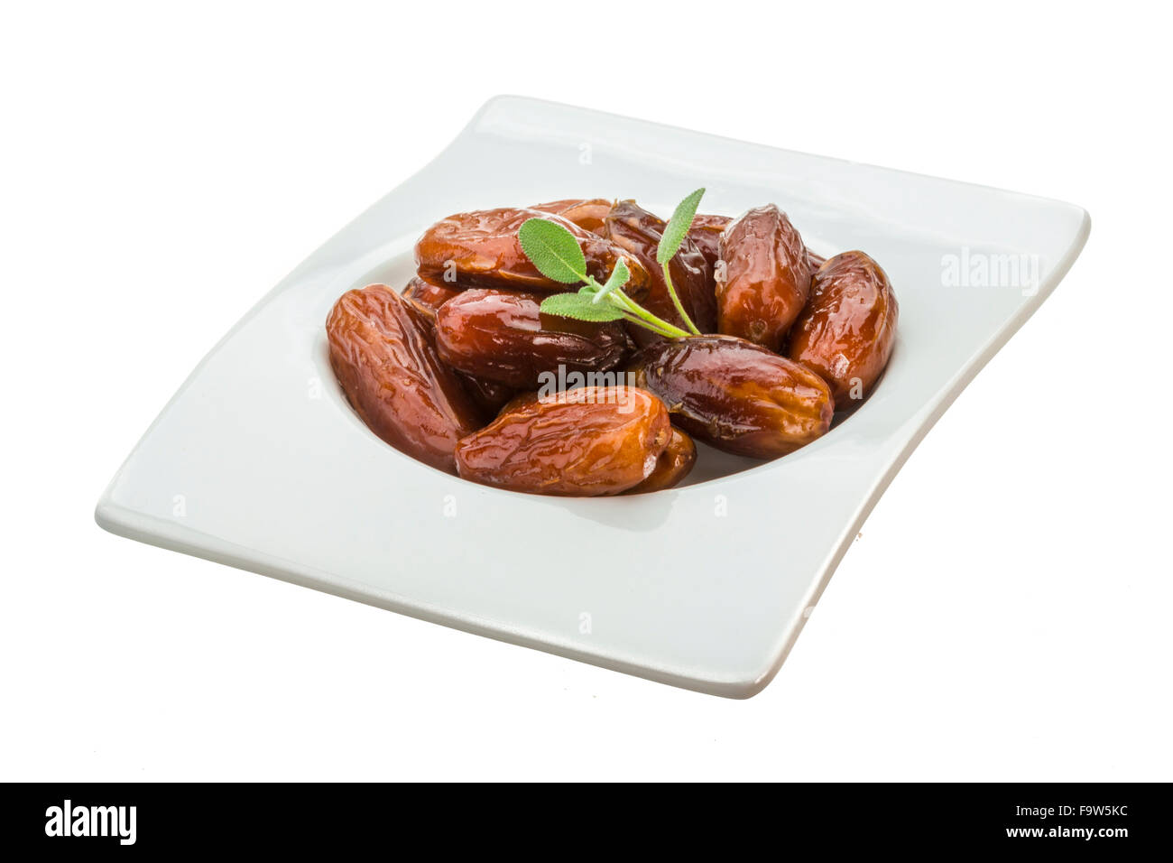Dates with leaf on the plate Stock Photo - Alamy