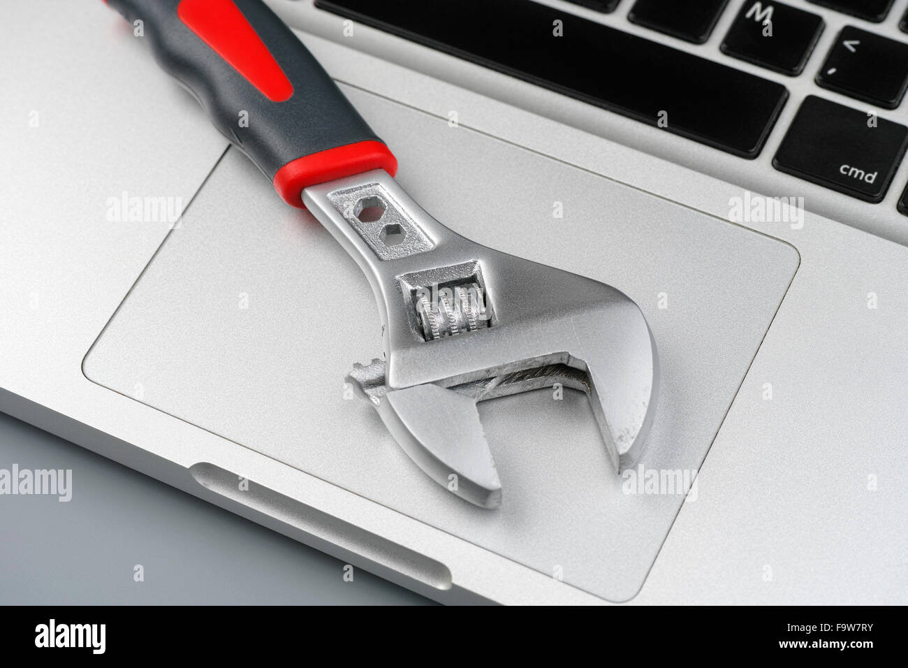 Laptop repair concept. Wrench on a laptop Stock Photo - Alamy