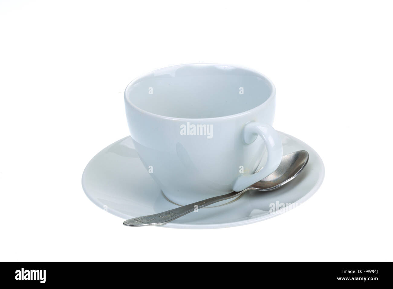 Empty cup with spoon Stock Photo - Alamy