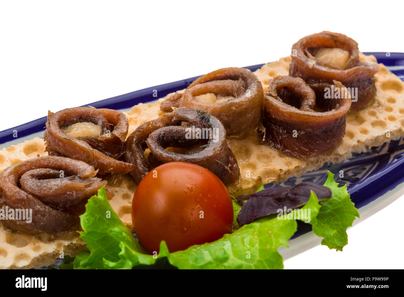 Anchovy snack with salad and tomato Stock Photo - Alamy
