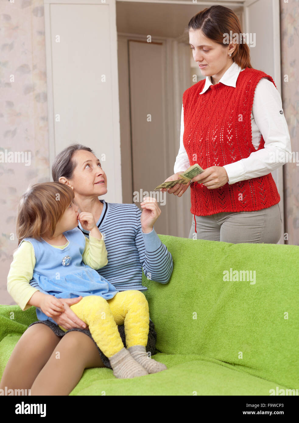 mother leaving baby with nanny at home Stock Photo - Alamy