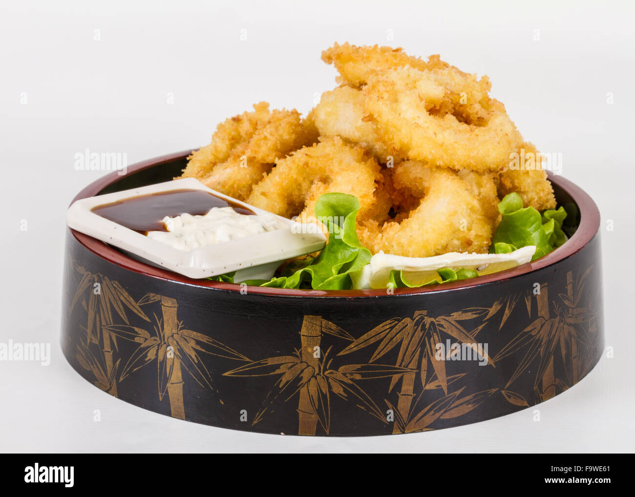 Deep batter fried squid rings calamari with green salad Stock Photo - Alamy