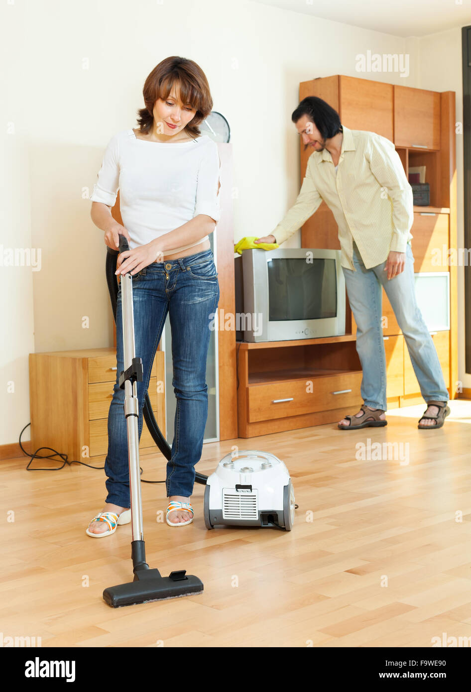 amicable woman and man doing housework together in home Stock Photo - Alamy