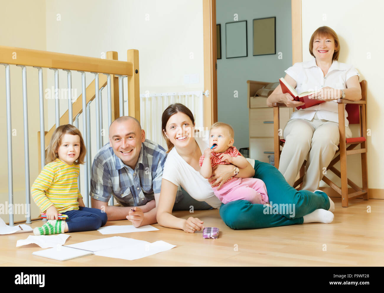 happy multigeneration family with two children enjoying at floor in ...
