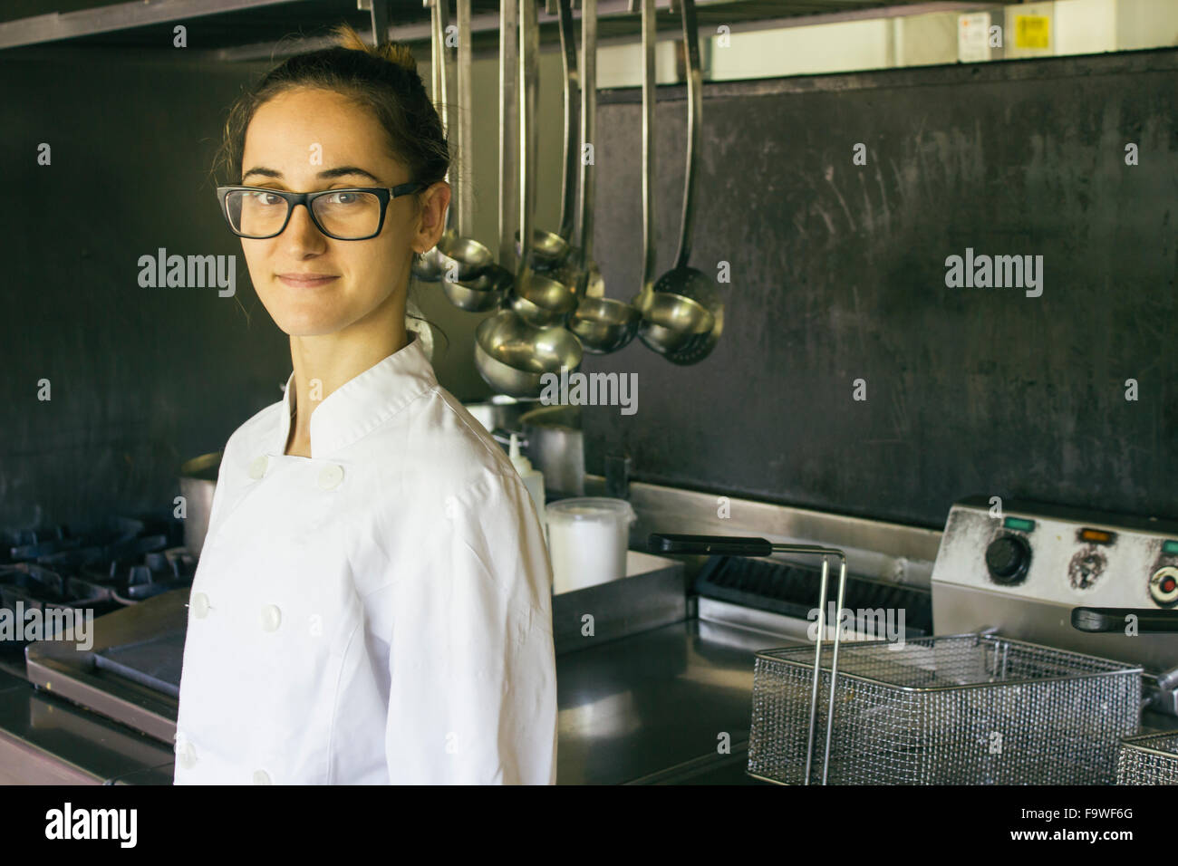 Young female chef in restaurant kitchen Stock Photo - Alamy
