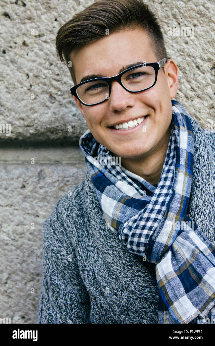 Portrait of smiling teenage boy with spectacles wearing scarf Stock ...