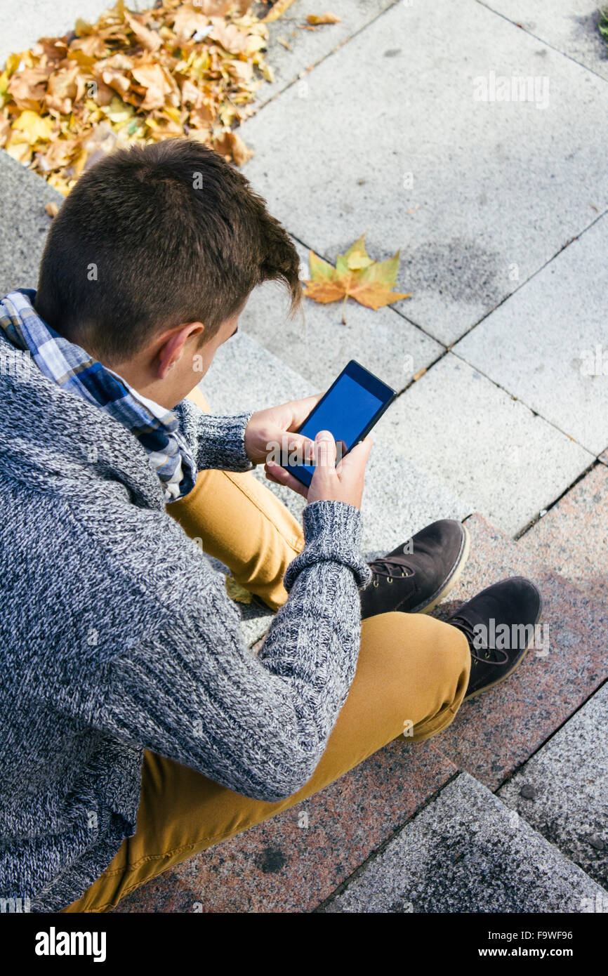 Teenage boy using smartphone Stock Photo - Alamy