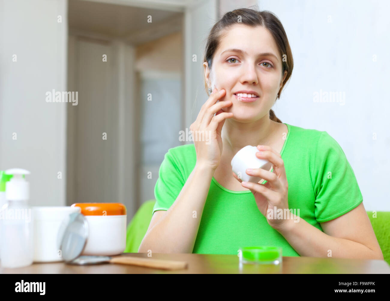 woman caring for her face with cosmetics Stock Photo - Alamy