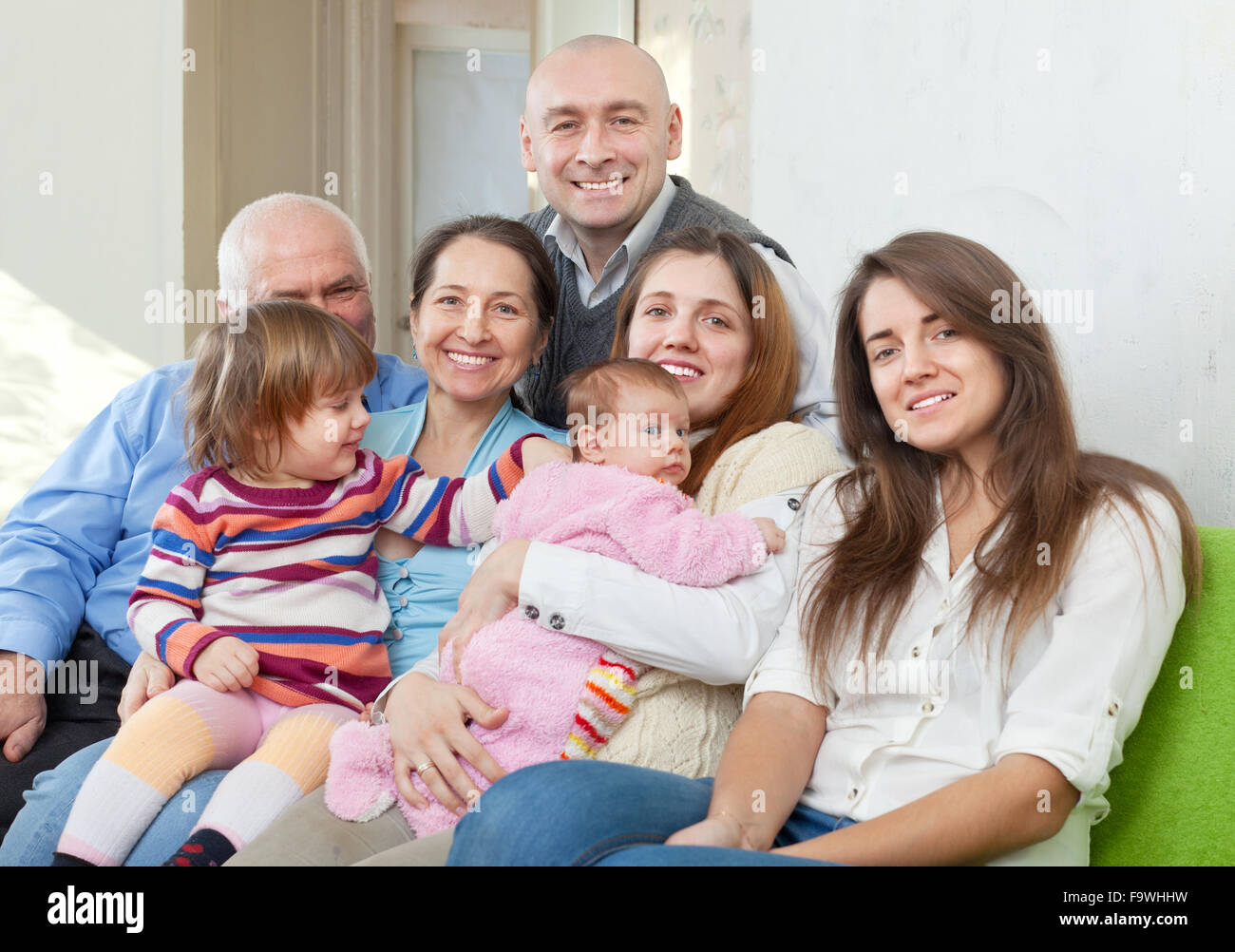 Happy three generations family in home interior Stock Photo - Alamy