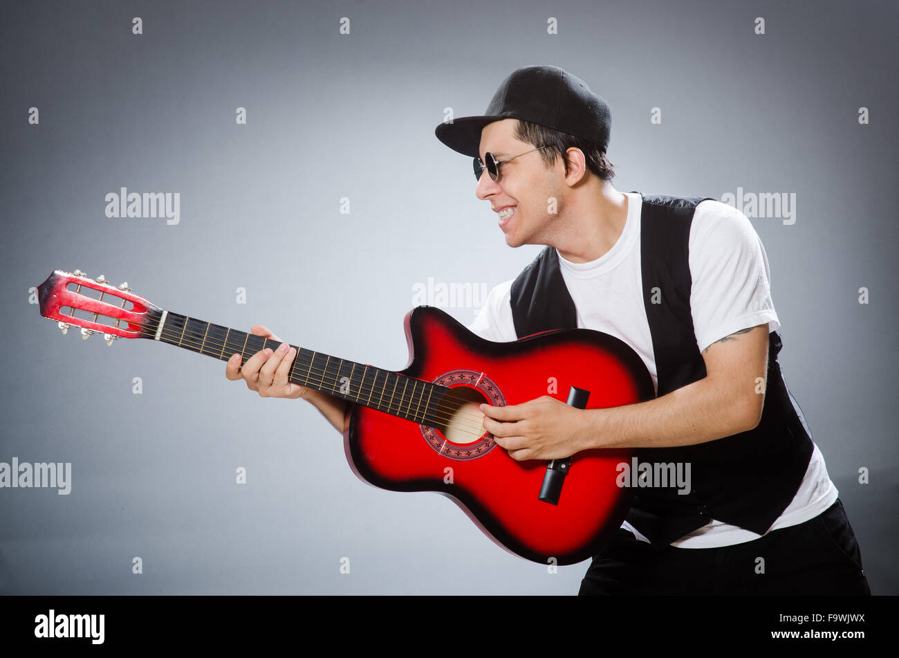 Funny guitar player in musical concept Stock Photo - Alamy