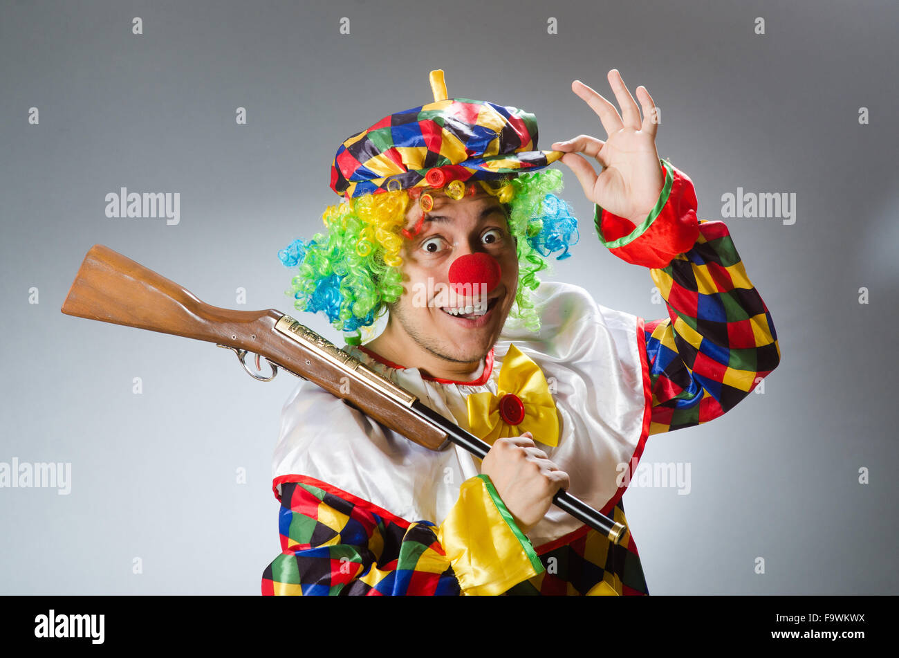 Clown with rifle isolated on white Stock Photo - Alamy