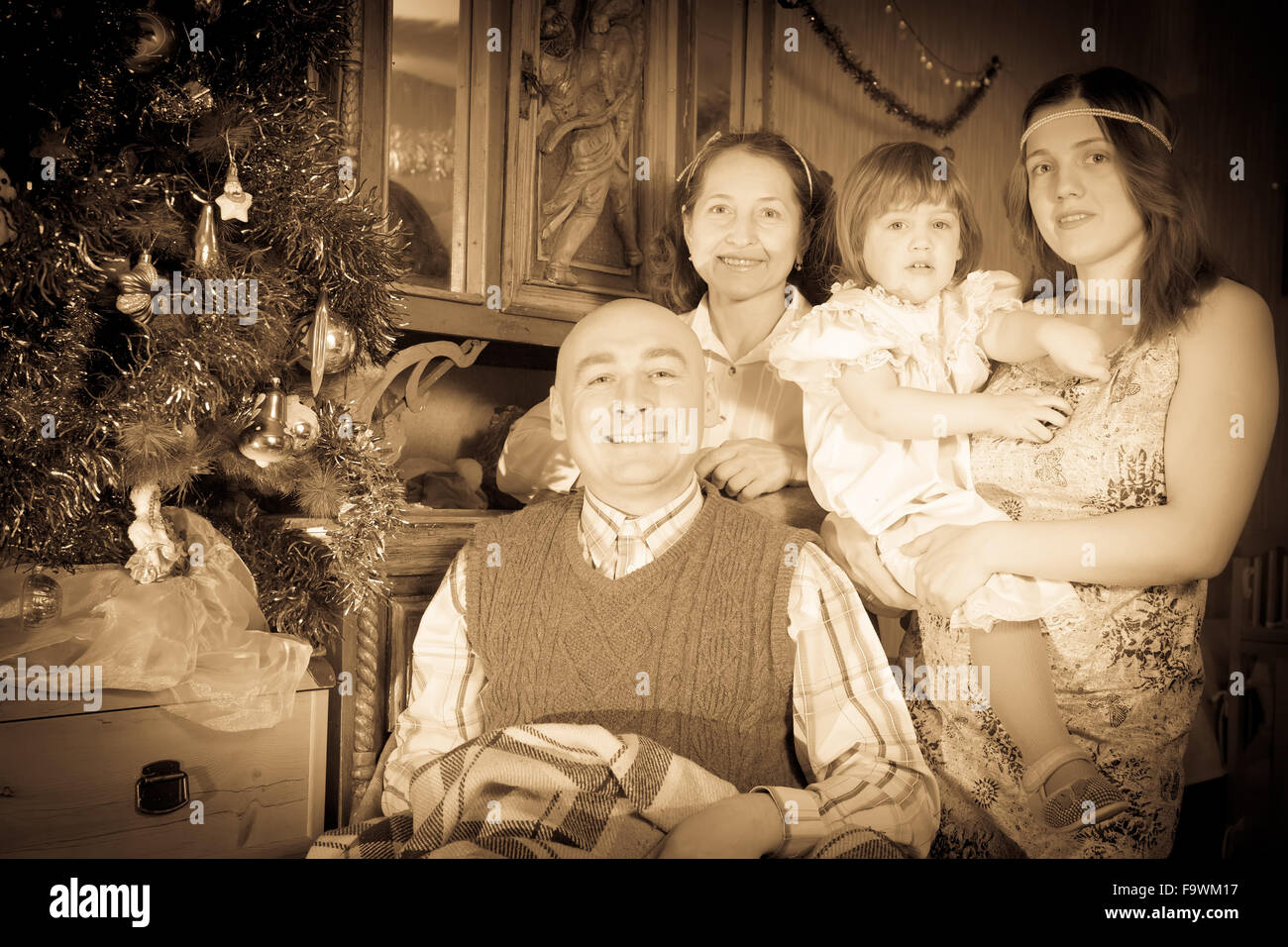 Retro photo of happy family of three generations celebrating Christmas ...