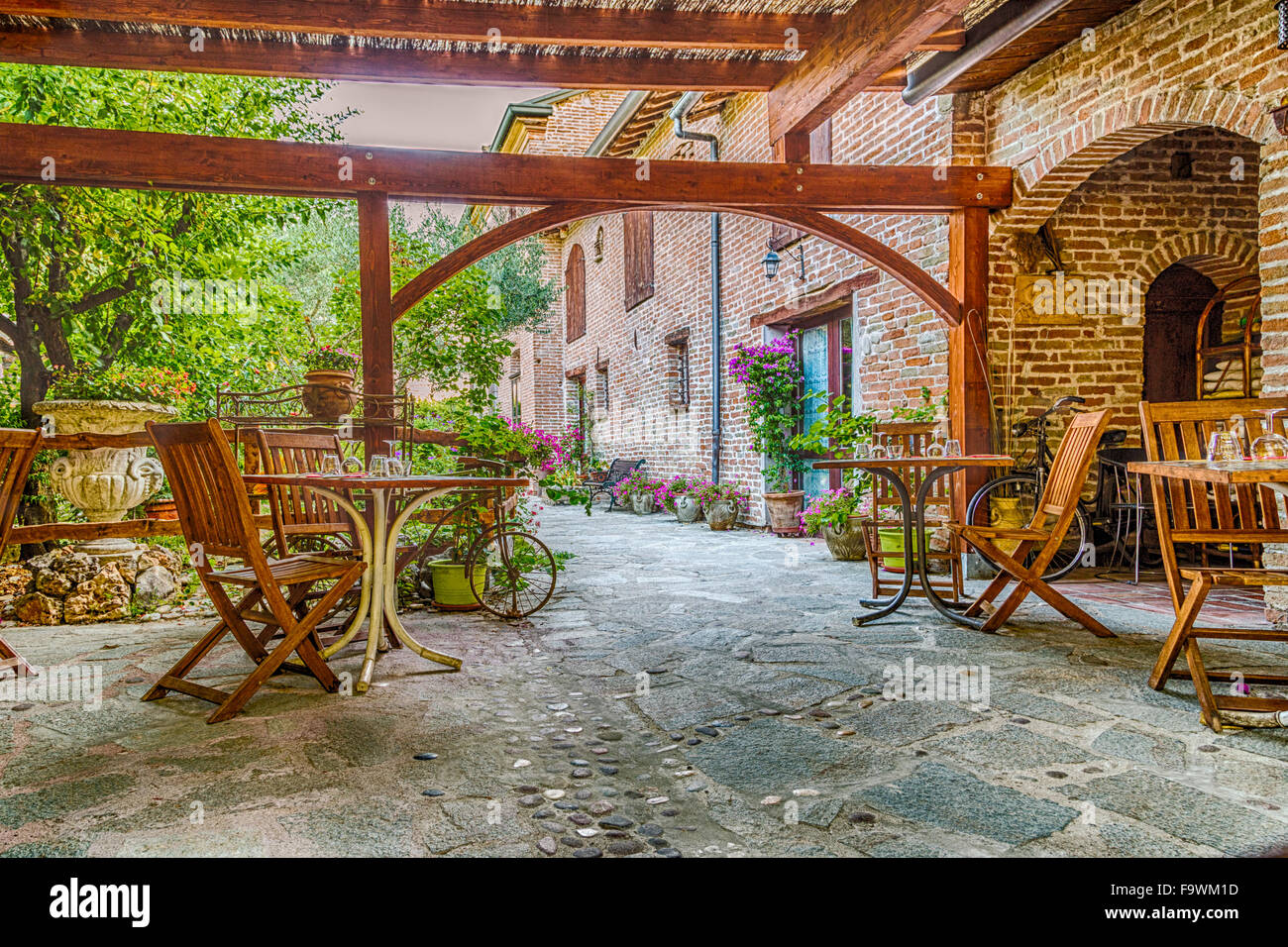Italian outdoor country restaurant,wooden chairs and tables set with ...