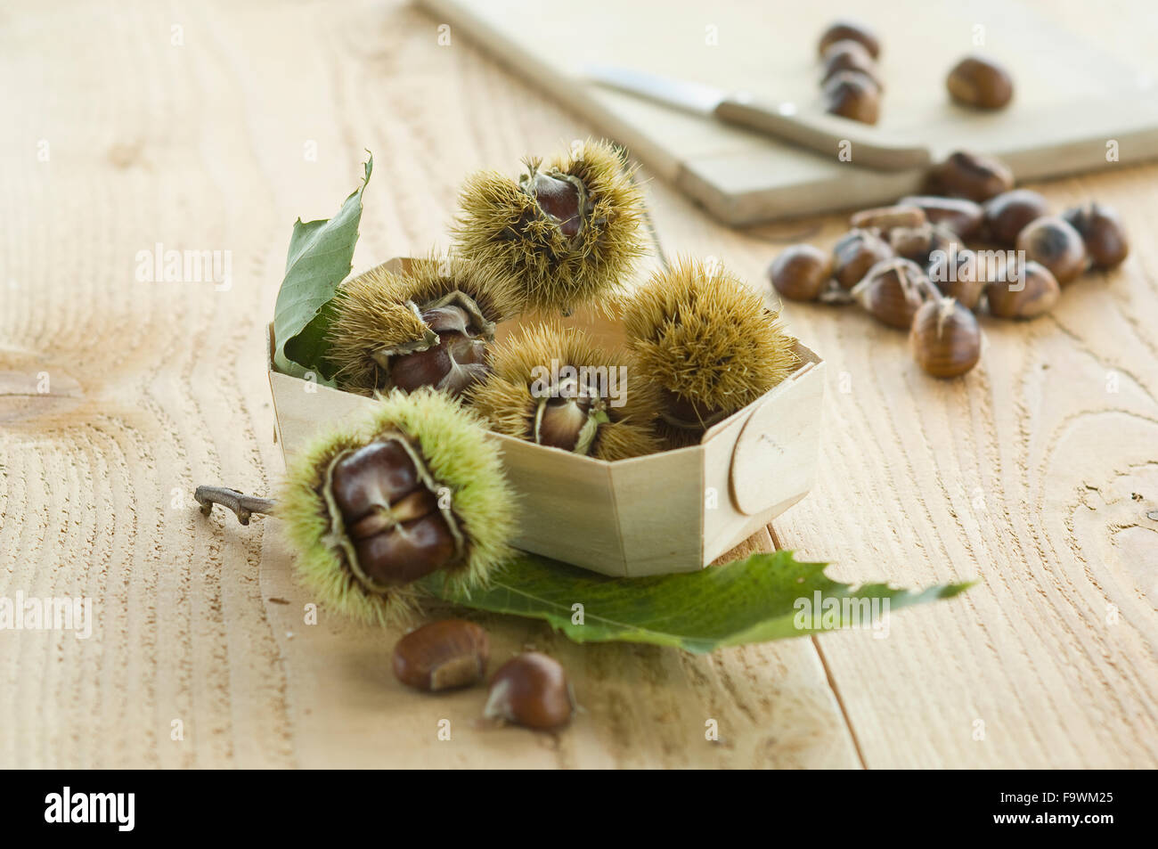 Box with sweet chestnuts on wood Stock Photo - Alamy