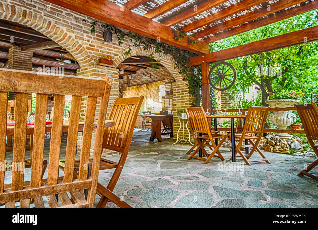 Italian outdoor country restaurant,wooden chairs and tables set with ...