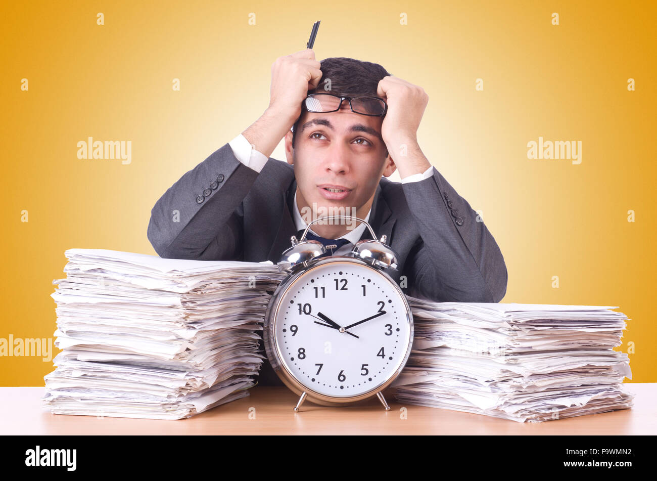 Woman businessman with giant alarm clock Stock Photo - Alamy