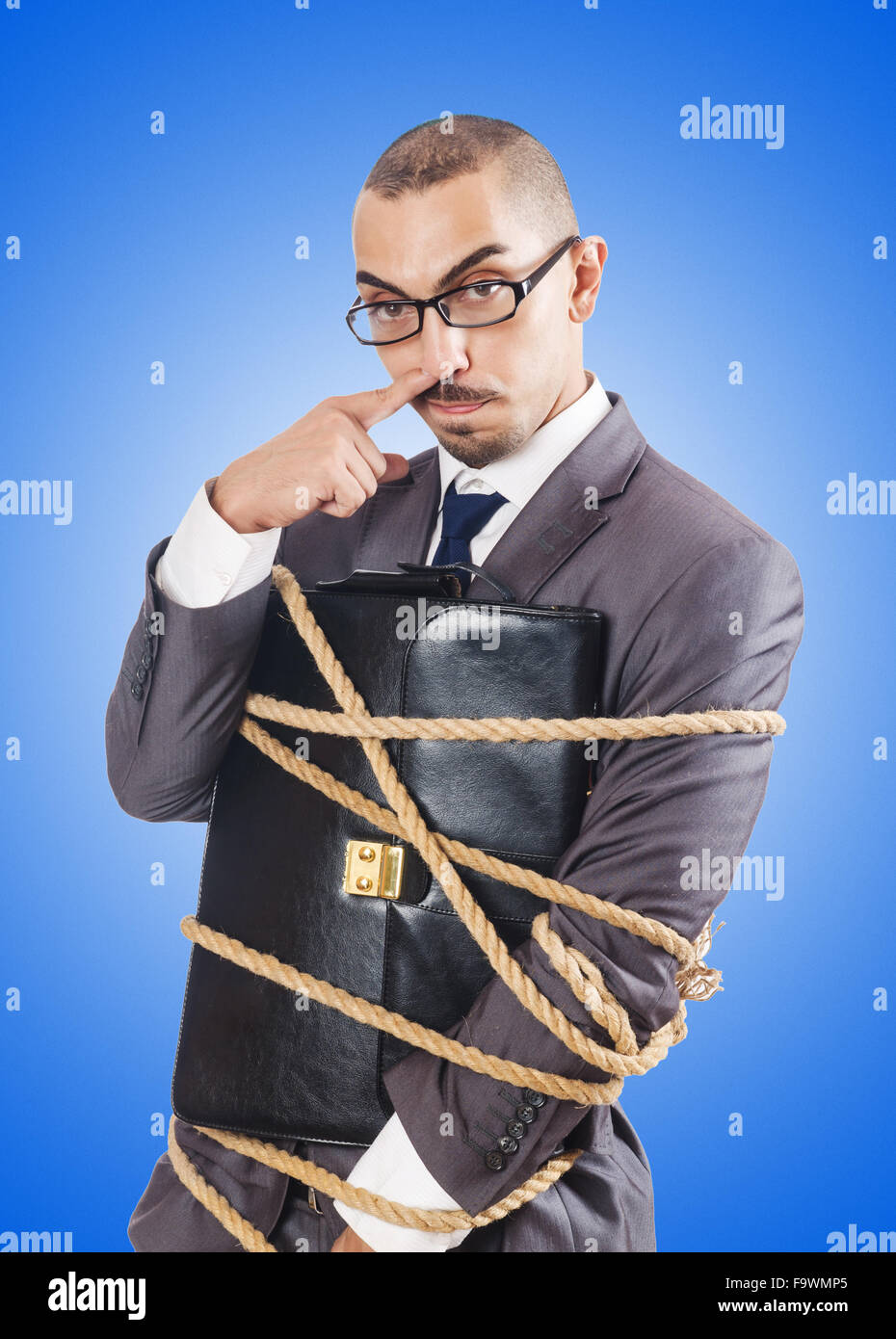 Businessman tied up with rope Stock Photo - Alamy