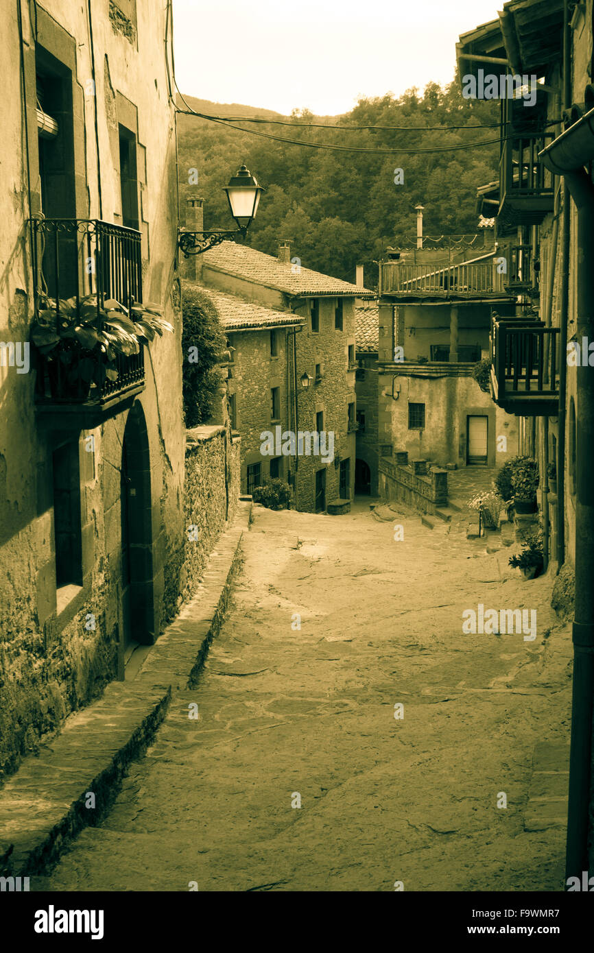 Retro photo of old picturesque view of medieval Catalan village. Rupit ...