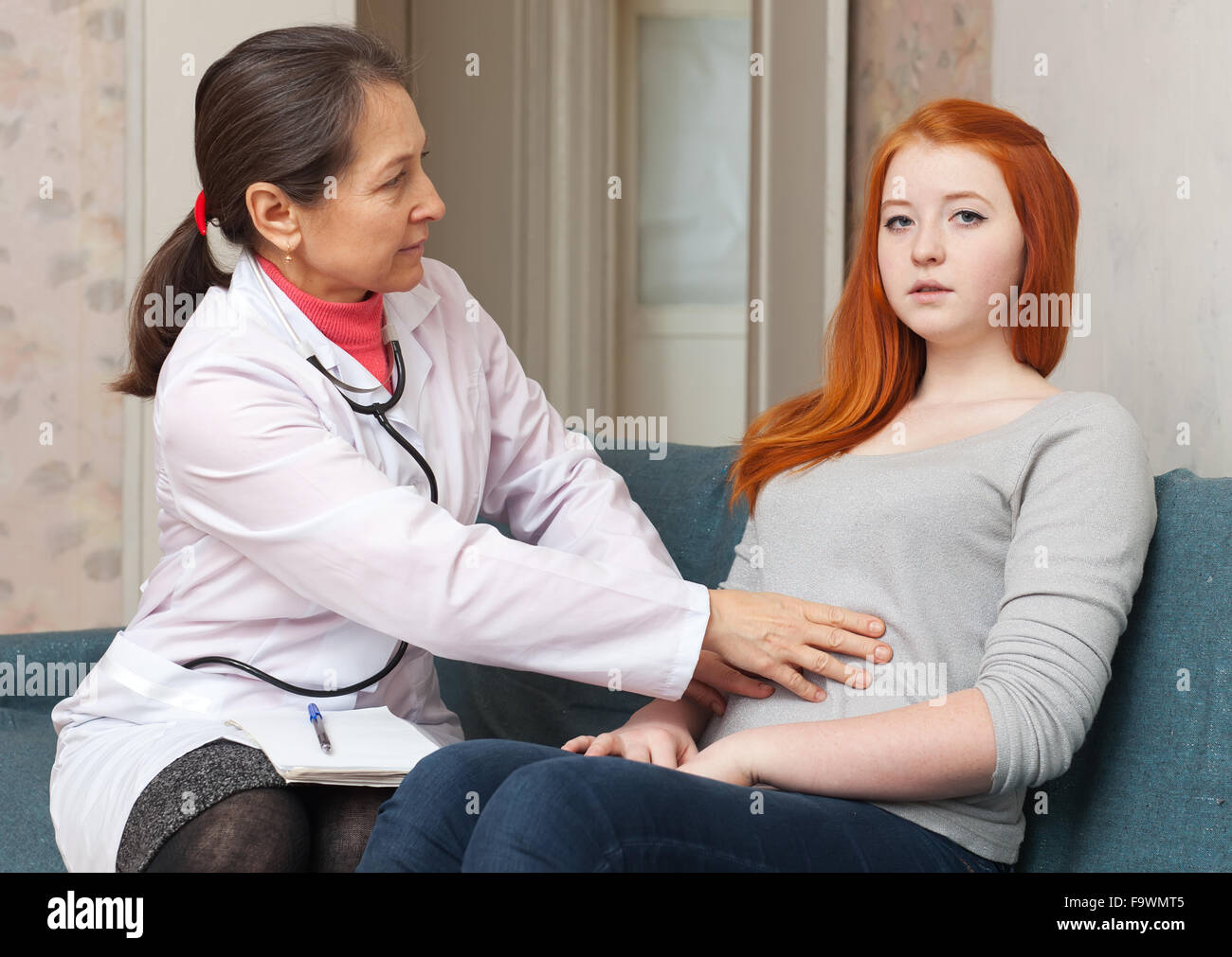 Doctor examining stomach girl hi-res stock photography and images - Alamy