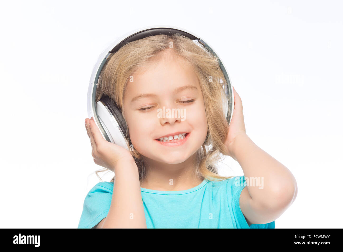 Little girl enjoying the music Stock Photo - Alamy