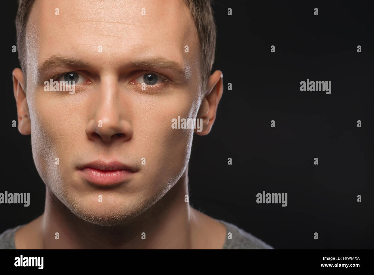 Handsome man looking serious Stock Photo - Alamy