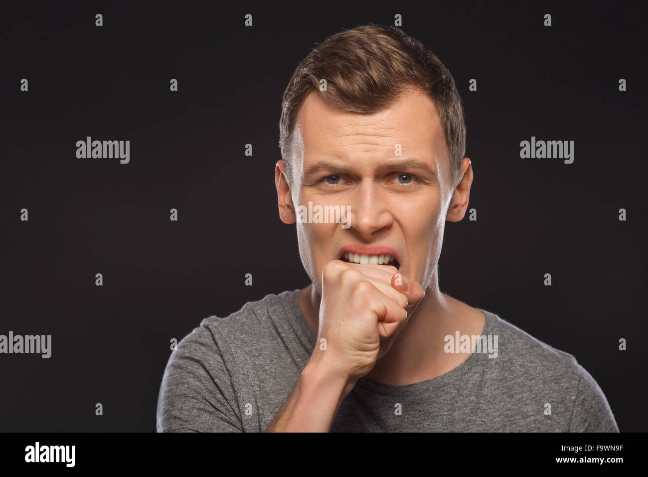 Young man looking frightened Stock Photo - Alamy