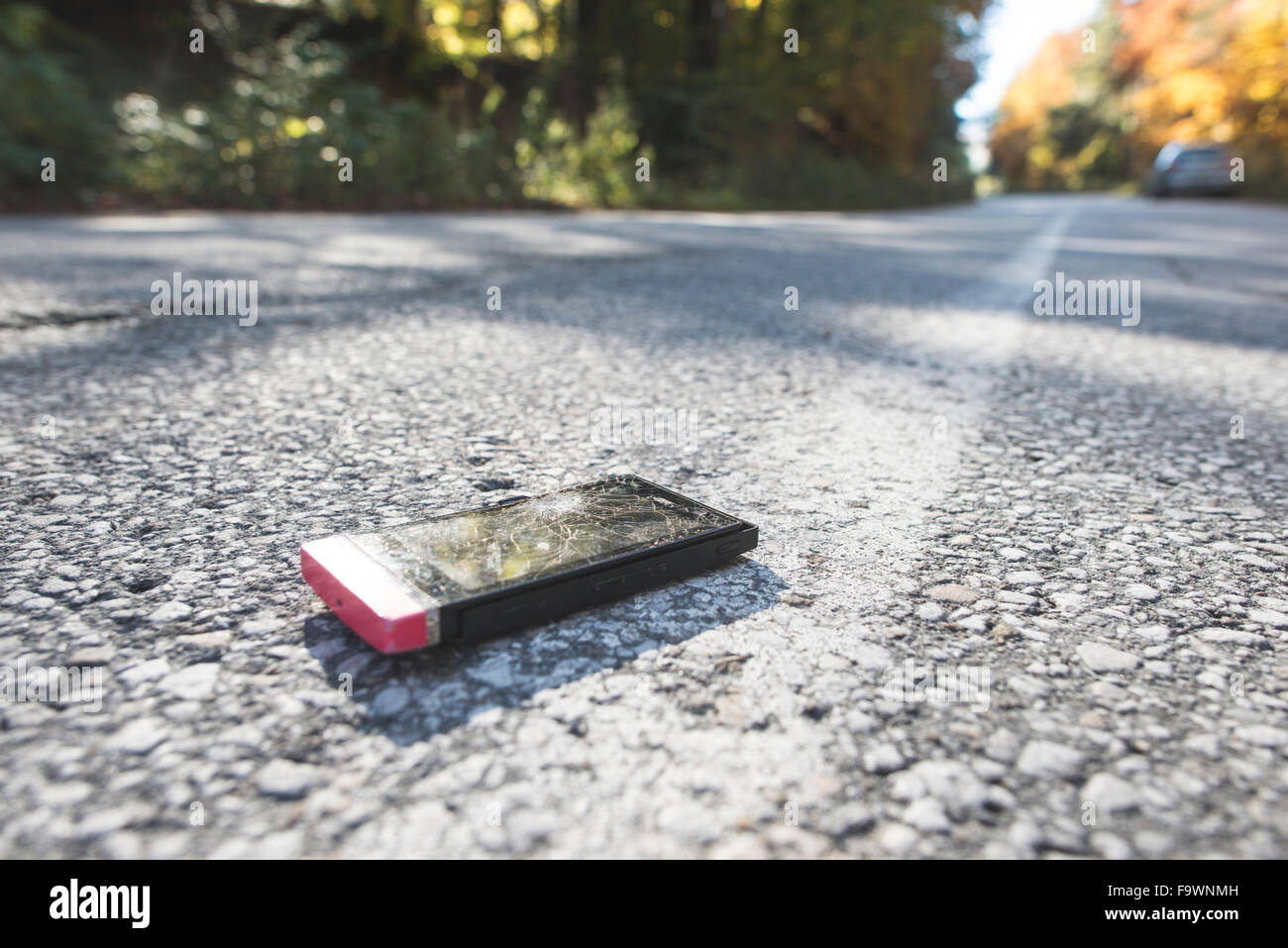 Broken smartphone lying on the road Stock Photo - Alamy