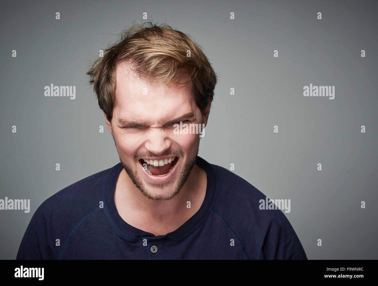 Portrait of angry young man Stock Photo - Alamy