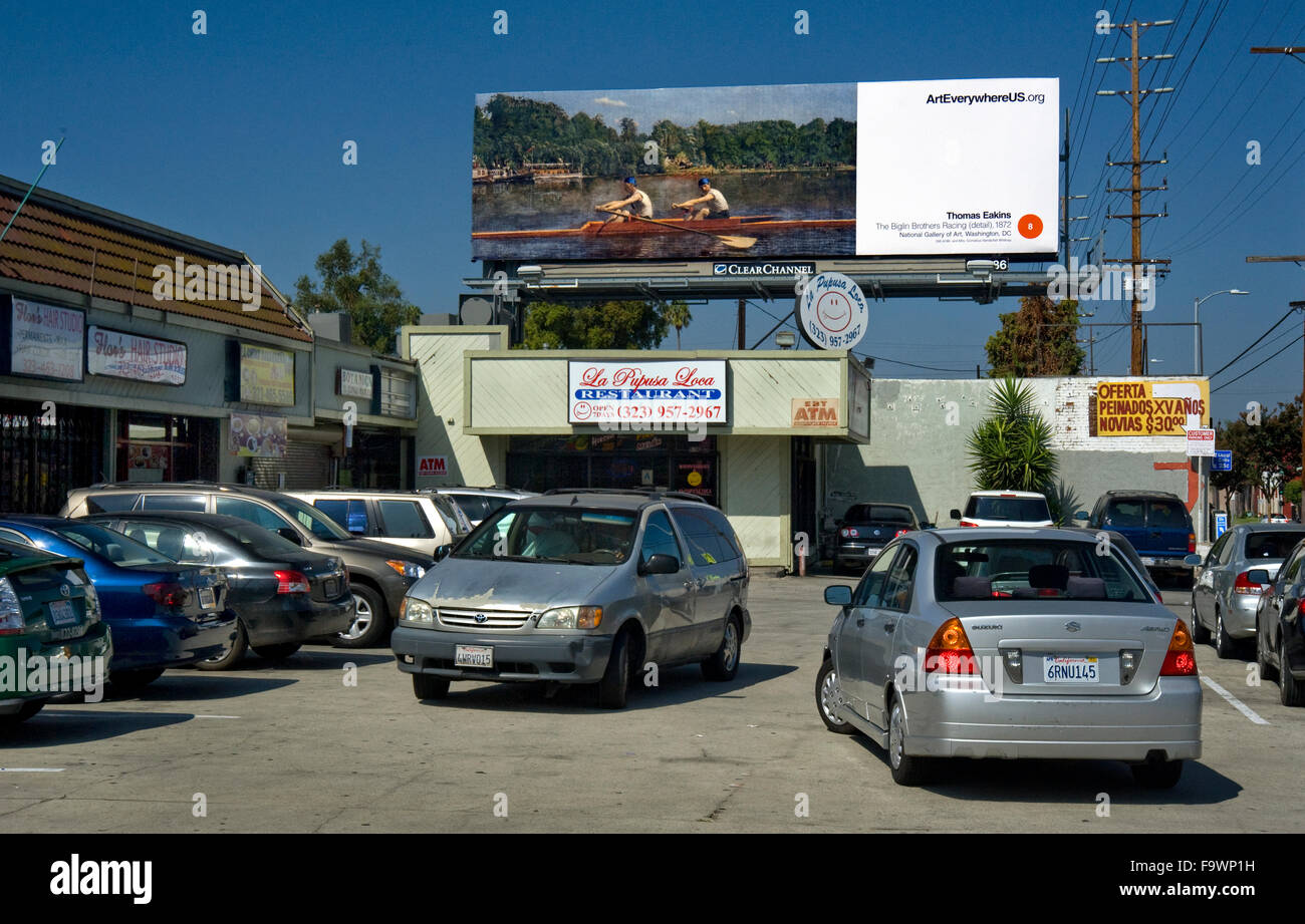 A Thomas Eakins painting appears on a billboard above a mini mall in ...