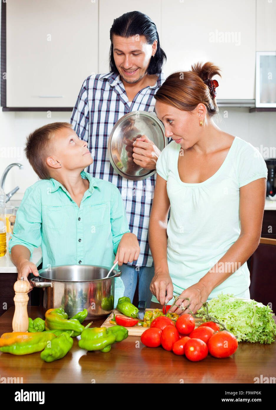 parents and teenager cooking together at home kitchen Stock Photo - Alamy