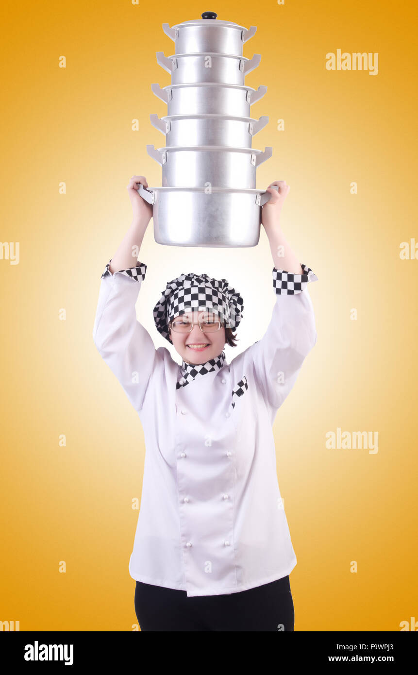 Cook with stack of pots on white Stock Photo - Alamy