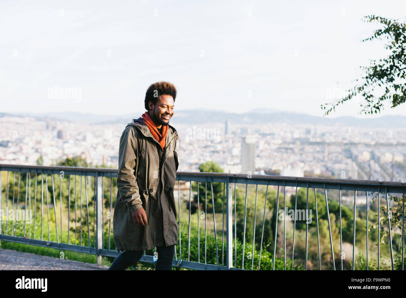 Spain, Barcelona, smiling young man on view terrace Stock Photo - Alamy