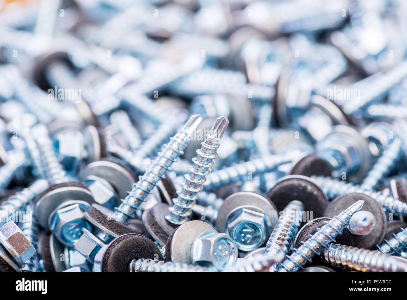 Many screws arranged as background Stock Photo - Alamy