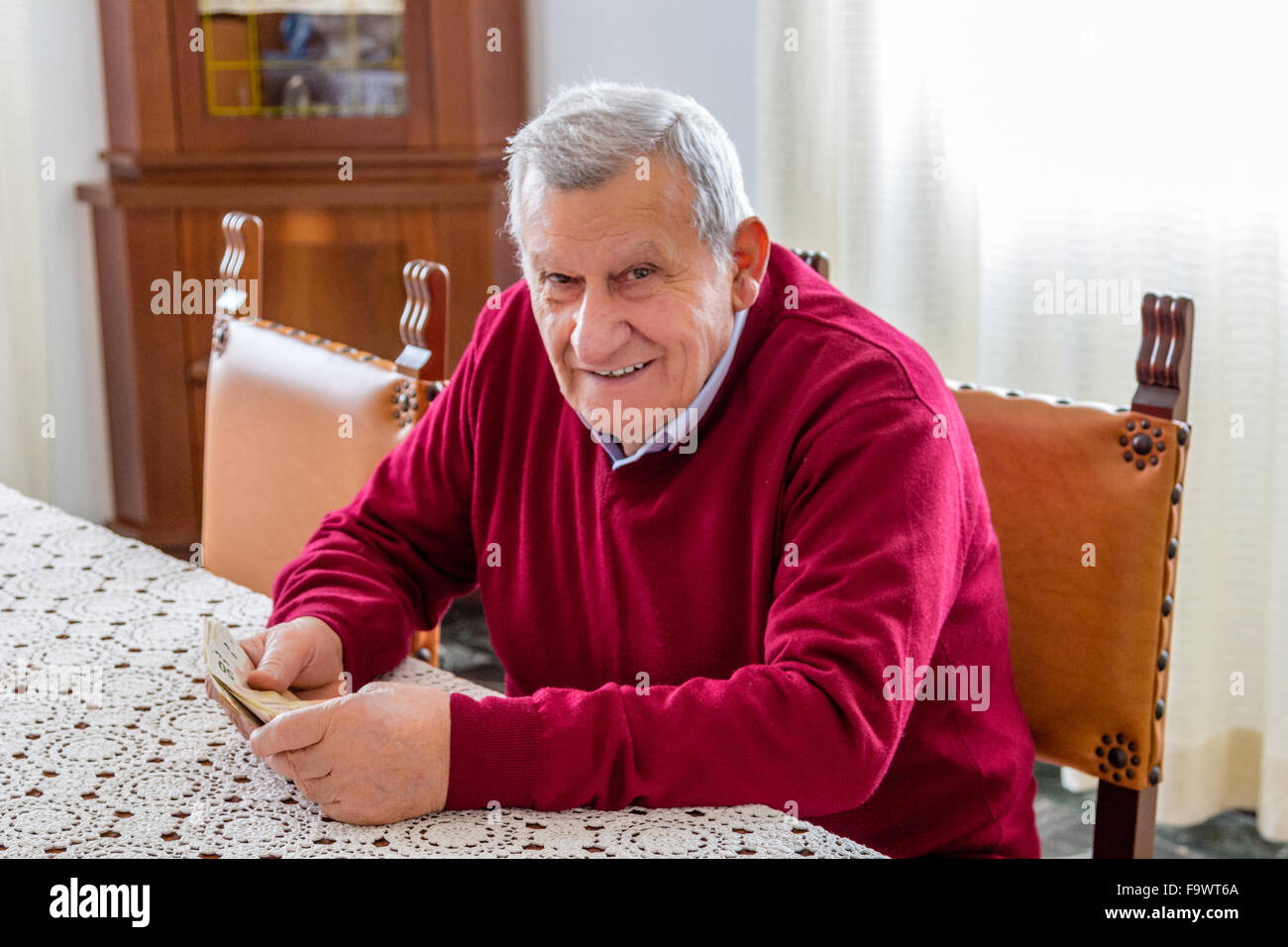 Old man sitting at table hi-res stock photography and images - Alamy
