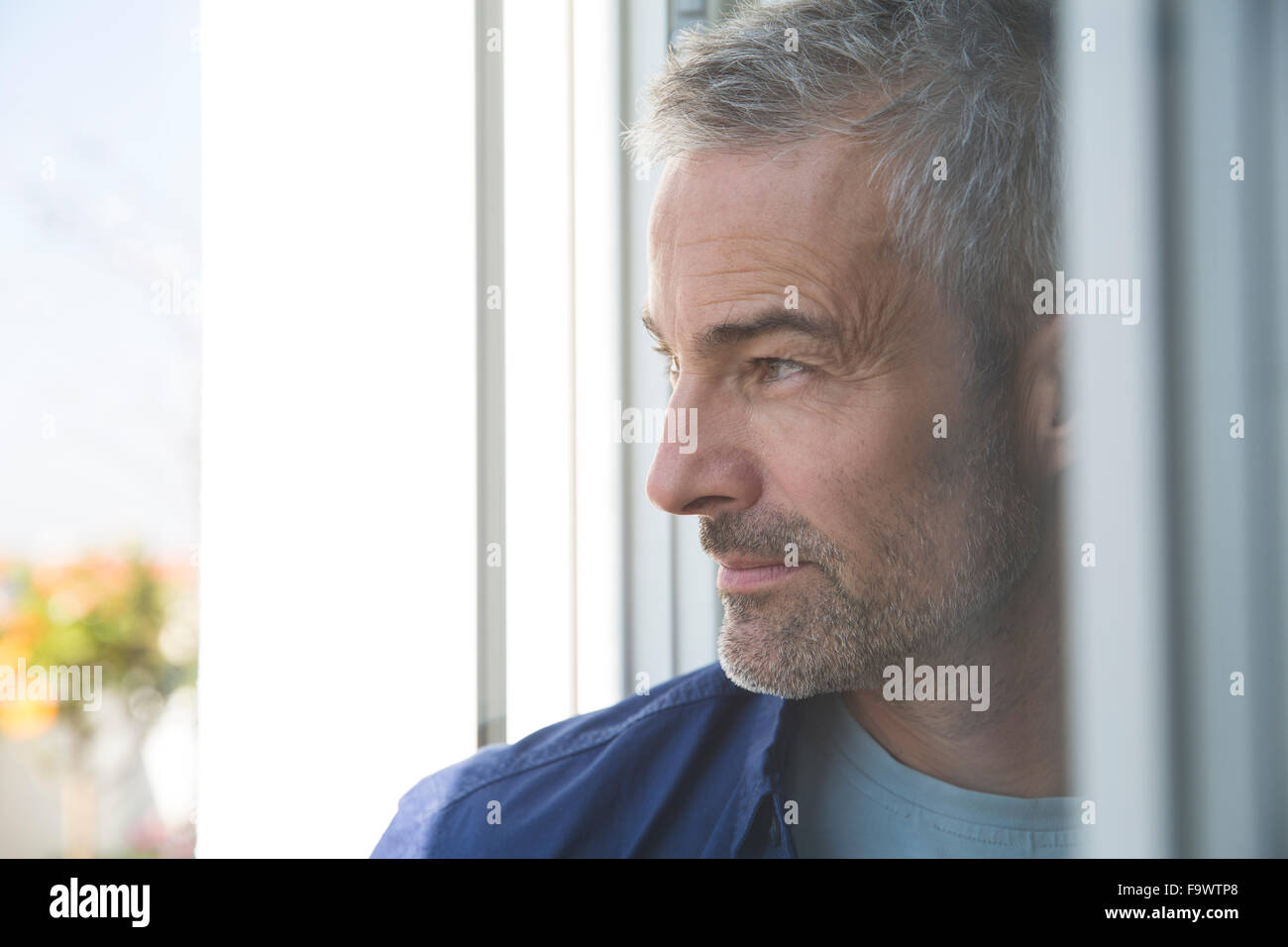 Portrait of a mature man at the window Stock Photo - Alamy