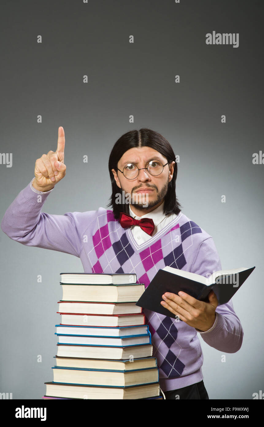Young student with book in learning concept Stock Photo - Alamy