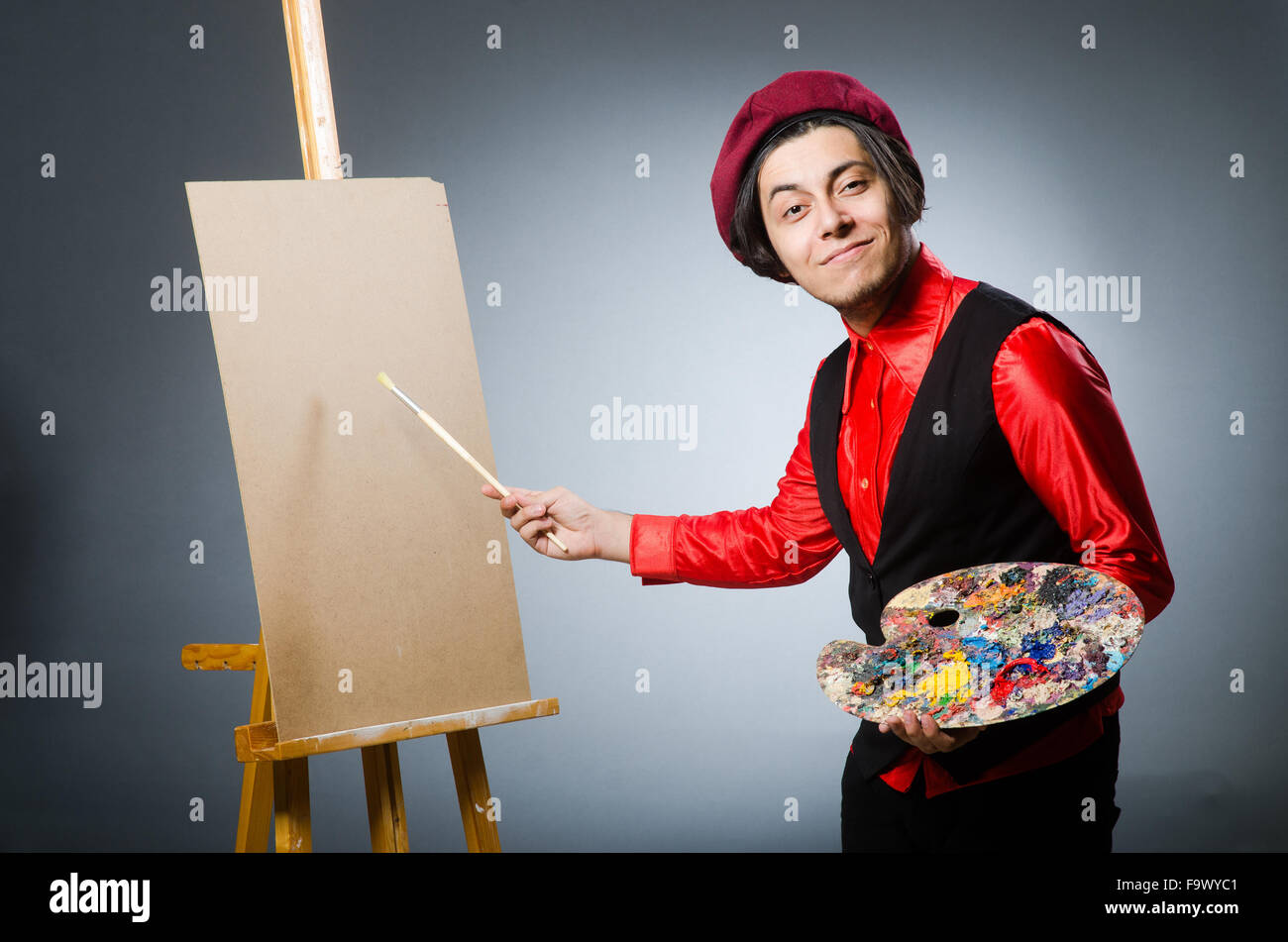 Funny artist in dark studio Stock Photo - Alamy
