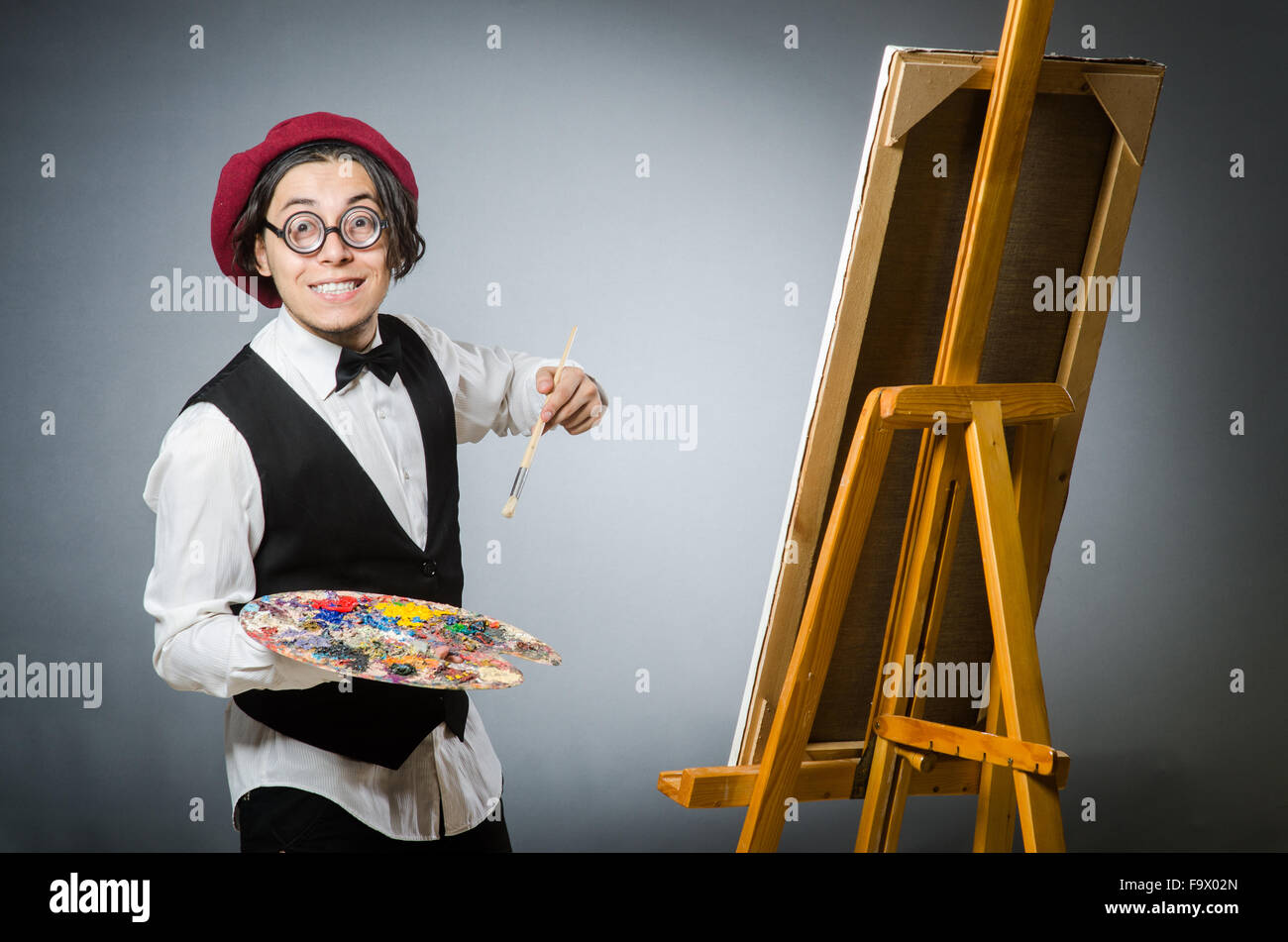Funny artist in dark studio Stock Photo - Alamy