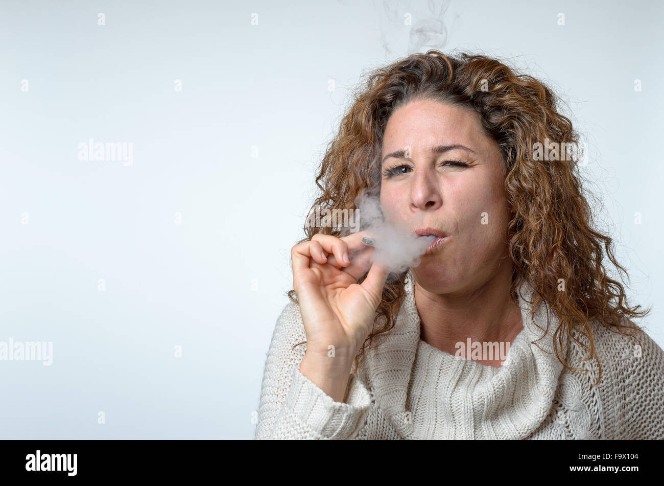 Young woman exhaling smoke hi-res stock photography and images - Alamy