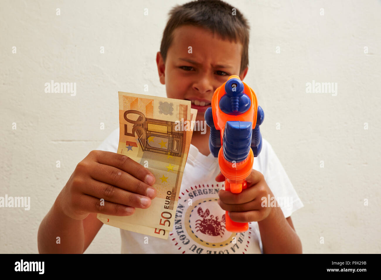 Boy playing cops and robbers Stock Photo - Alamy