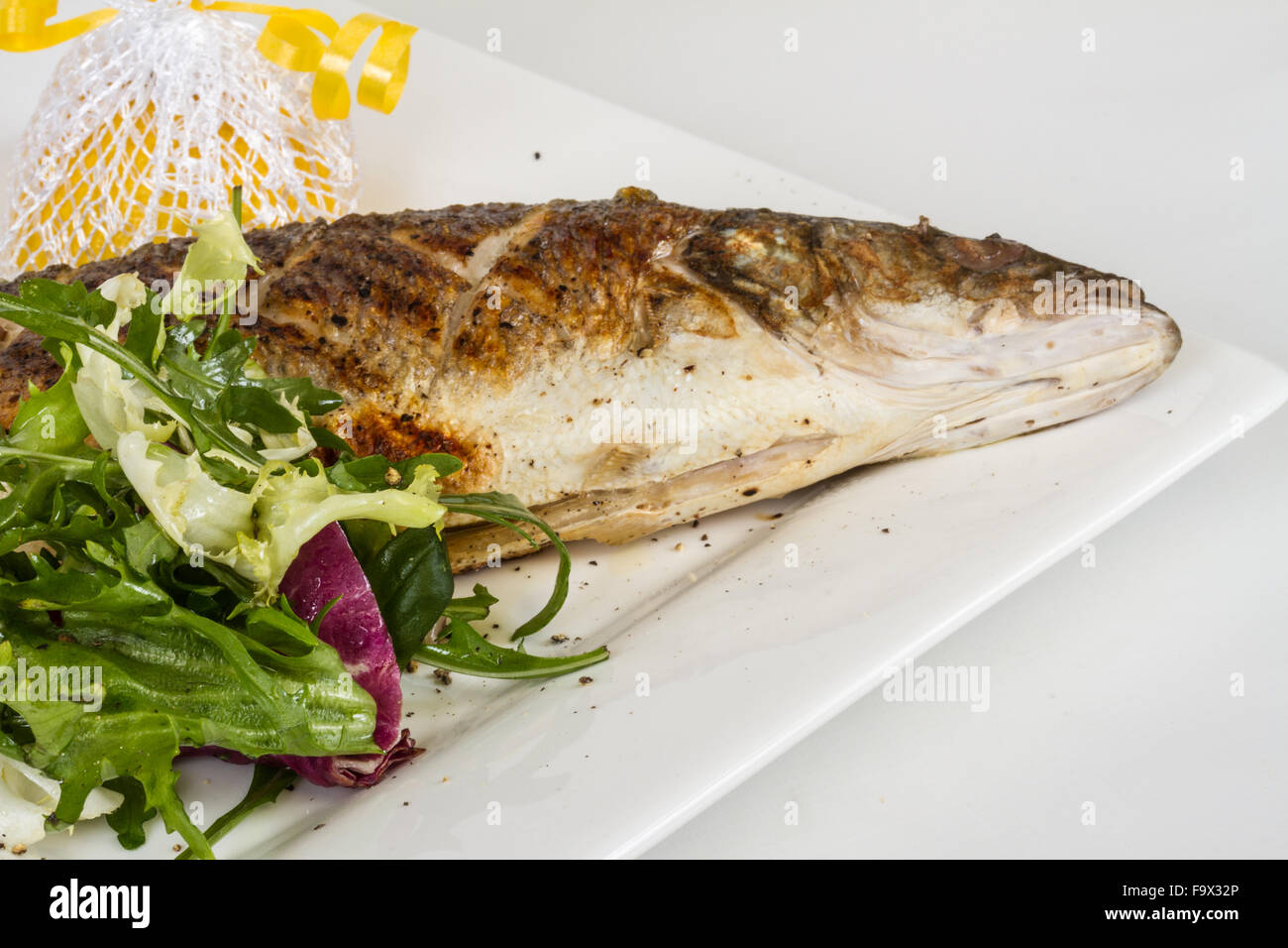 Sea-bass with vegetables Stock Photo - Alamy