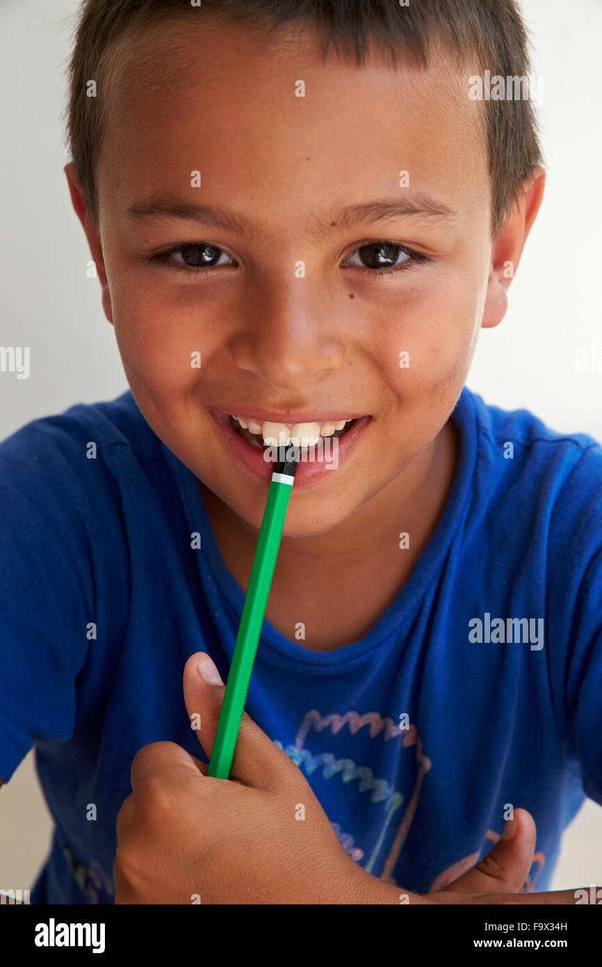 Smiling boy holding a pencil Stock Photo - Alamy